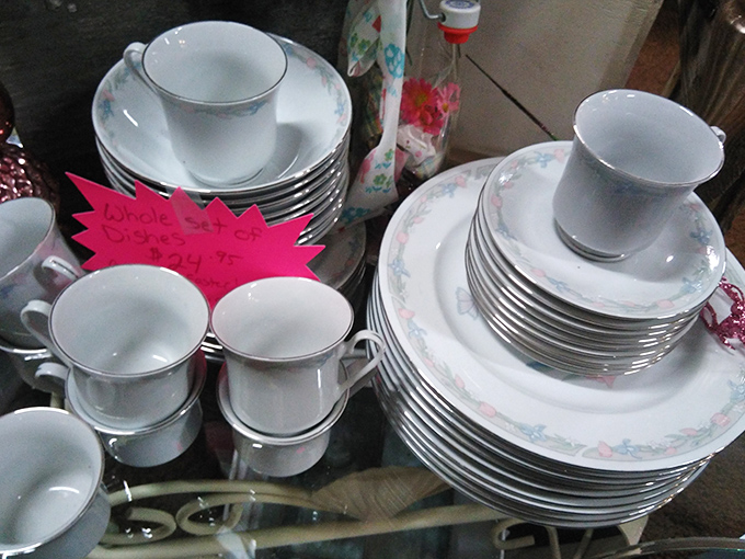 Delicate china tea sets stand in pristine formation, ready to transform your ordinary afternoon into a scene from "Downton Abbey."