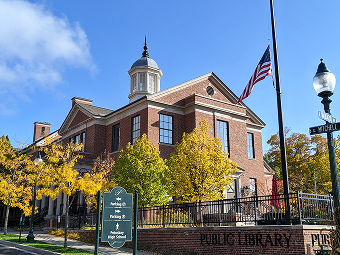The Petoskey District Library stands proud in autumn gold, a temple to knowledge where architecture and literature create the perfect Michigan marriage.