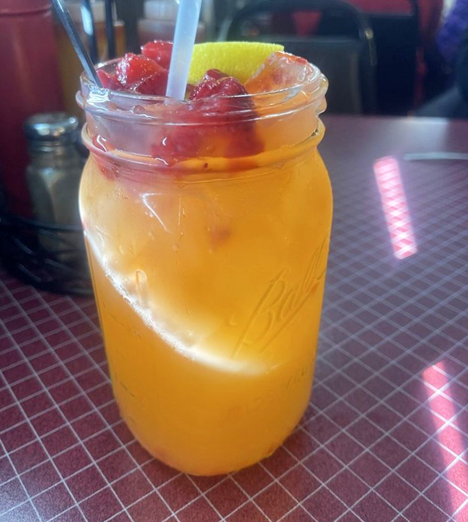 A mason jar isn't just a drinking vessel; it's a declaration that this sweet tea with fruit garnish means serious refreshment business.