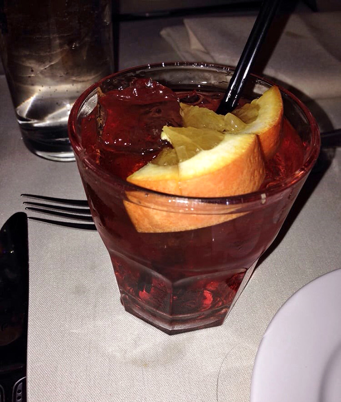 A classic Negroni with orange slices – the kind of cocktail that makes you want to toast to la dolce vita.