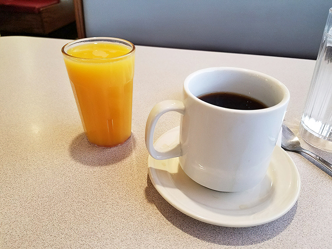 The universal breakfast diplomats: coffee black as midnight and orange juice bright as sunrise, negotiating peace between night and day.