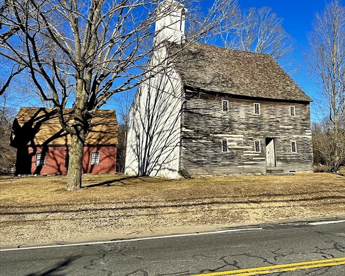 The Eleazer Arnold House has weathered centuries of New England winters, its stone chimney standing like a colonial exclamation point.