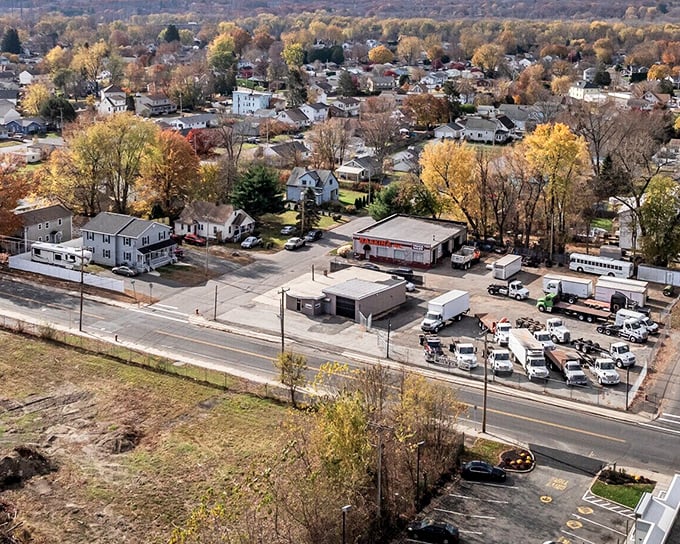 Chicopee's commercial district nestled among autumn foliage proves that even practical places for errands can look like paintings when the seasons change.