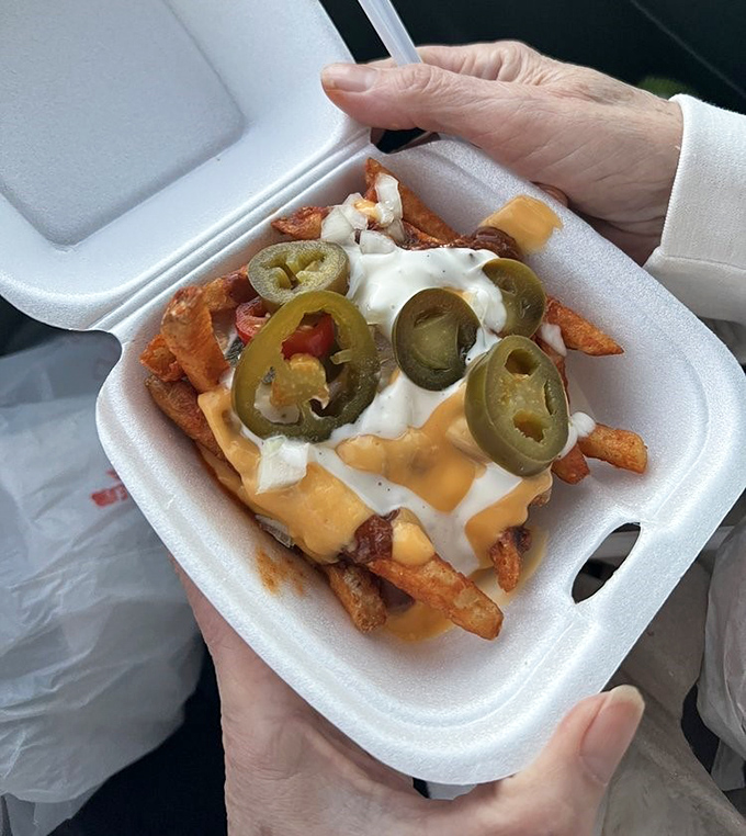 Extreme Fries living up to their name – jalapeños standing guard over a treasure of cheese, sour cream, and crispy potatoes.
