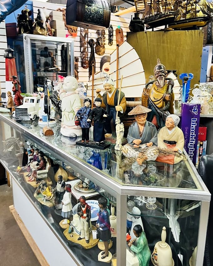 Asian figurines stand in silent dignity behind glass. Each porcelain face tells a story, waiting for the right collector to bring them home.