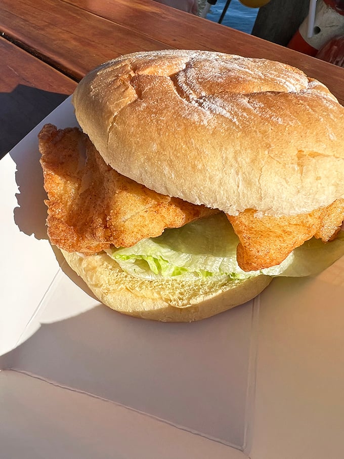 A fish sandwich that would make Poseidon himself stand in line. Crispy, flaky, and fresh&mdash;the holy trinity of seafood satisfaction on a pillowy bun.