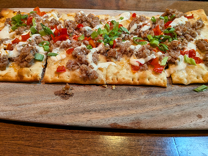 This flatbread brings enough toppings to qualify as a full meal disguised as an appetizer.