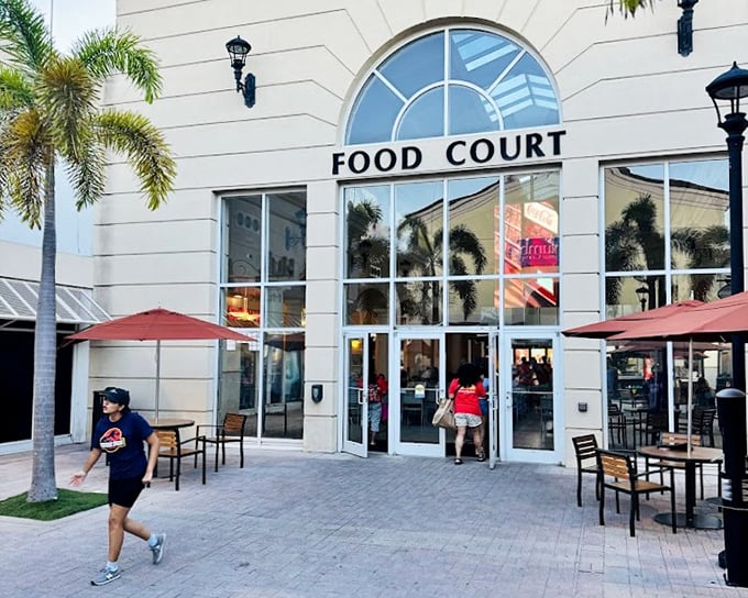 The food court entrance promises sustenance for weary shoppers&mdash;the retail equivalent of an oasis after crossing a desert of discounted designer goods.