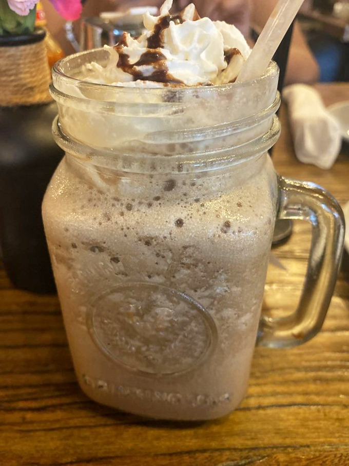 Coffee gets dressed up for the occasion in this mason jar masterpiece—topped with whipped cream and caramel drizzle, it's dessert masquerading as morning fuel.