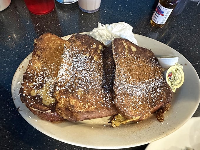 French toast that's crossed the line from breakfast to dessert and isn't apologizing. Powdered sugar snowfall makes resistance futile.