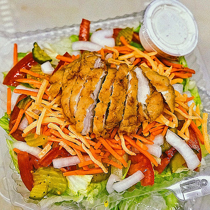 A fried chicken salad that proves vegetables are just a vehicle for delivering more fried chicken to your mouth.