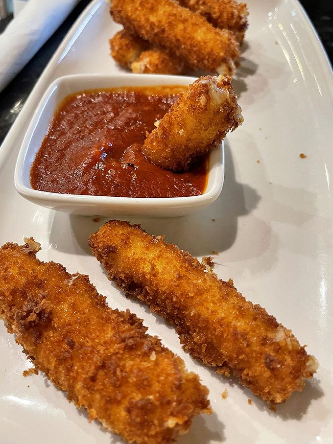 Golden-fried mozzarella sticks with marinara for dipping&mdash;proof that sometimes the simplest pleasures are the most satisfying. Crispy, gooey perfection.