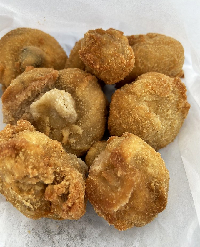 Fried mushrooms that achieve the impossible: maintaining their earthy soul while donning a crispy golden jacket that crackles with each bite.