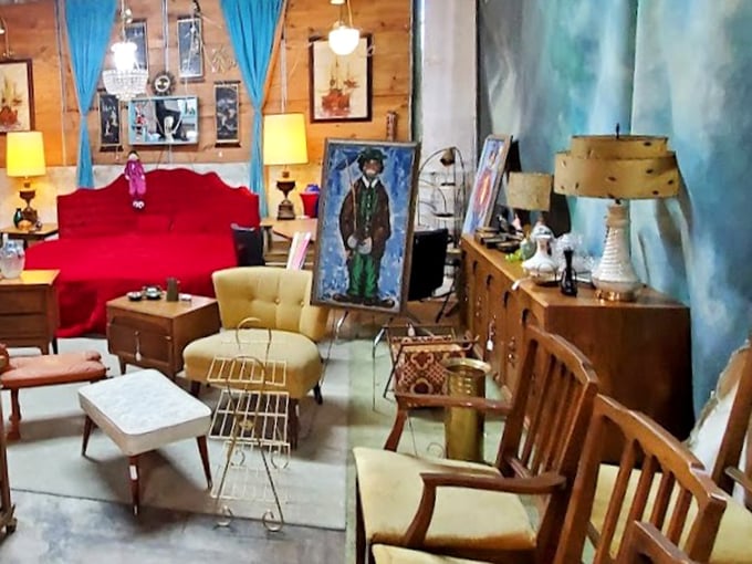 Mid-century furniture arranged like a living room frozen in time. That red sofa has hosted conversations we can only imagine. 