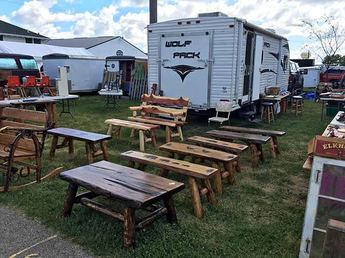 Rustic benches waiting for new homes. Each one hand-crafted with the kind of workmanship that makes modern furniture look like it's made of popsicle sticks.