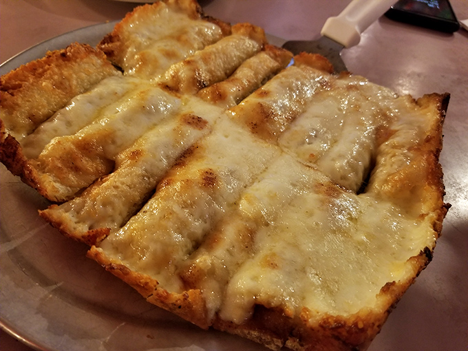 Garlic cheese bread so perfectly golden and gooey, it makes you wonder why we bother with other food groups.