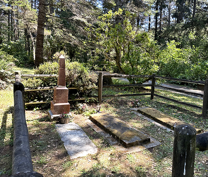 History whispers through this forest cemetery, where weathered stones tell tales of pioneers who chose this slice of paradise as their eternal home.
