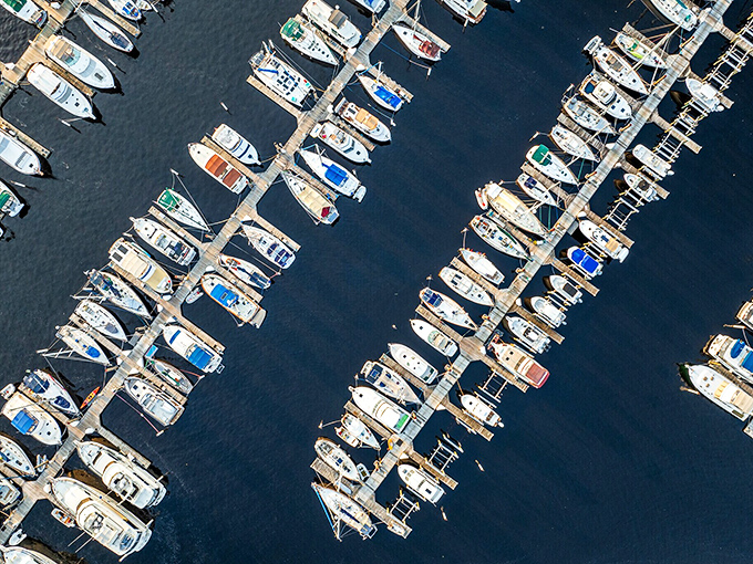 The marina's perfect symmetry of boats creates a nautical ballet that whispers, "Yes, you absolutely should consider buying that boat you've been eyeing."