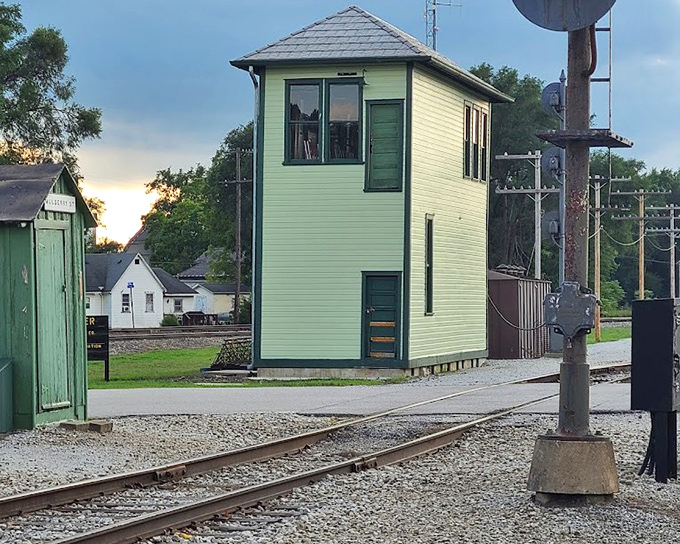 This mint-green signal tower once housed the railroad equivalent of air traffic controllers, coordinating train movements with a ballet of levers, bells, and telegraphs.