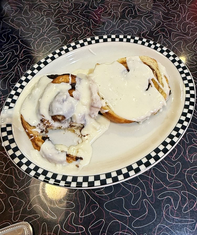 A classic cheeseburger and fries served on a checkered paper&mdash;proof that simplicity, when done right, needs no explanation.
