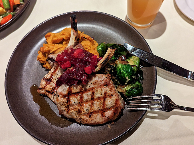 A pork chop that's been kissed by fire and topped with tangy cranberry compote&mdash;the kind of dish that makes you close your eyes on the first bite.