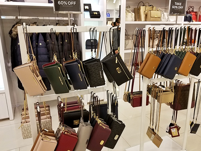 Handbags displayed with military precision, their gold chains and bold colors silently whispering, "You deserve me" to passing shoppers.