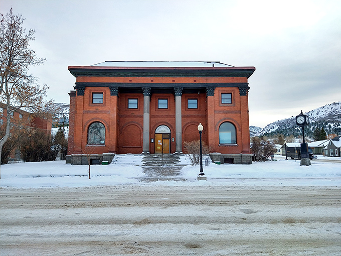 The Hearst Free Library's stately brick facade has weathered Montana winters since 1898, offering literary escapes that cost even less than the town's housing.