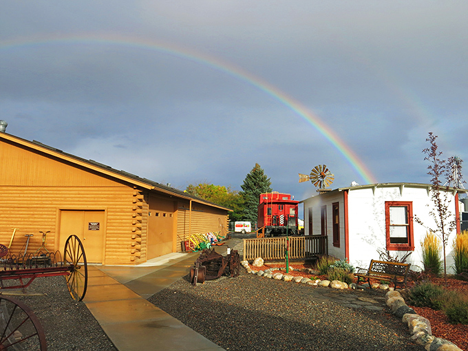The Homesteader Museum under a perfect rainbow feels like the universe confirming you've made the right choice to visit Powell.
