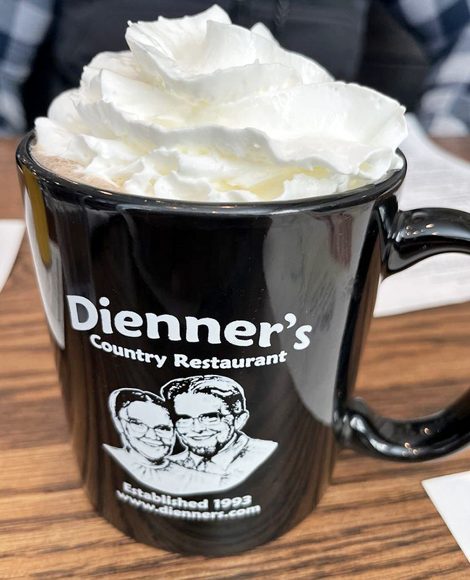 Hot cocoa topped with whipped cream in a souvenir mug makes everything right with the world, one sip at a time.