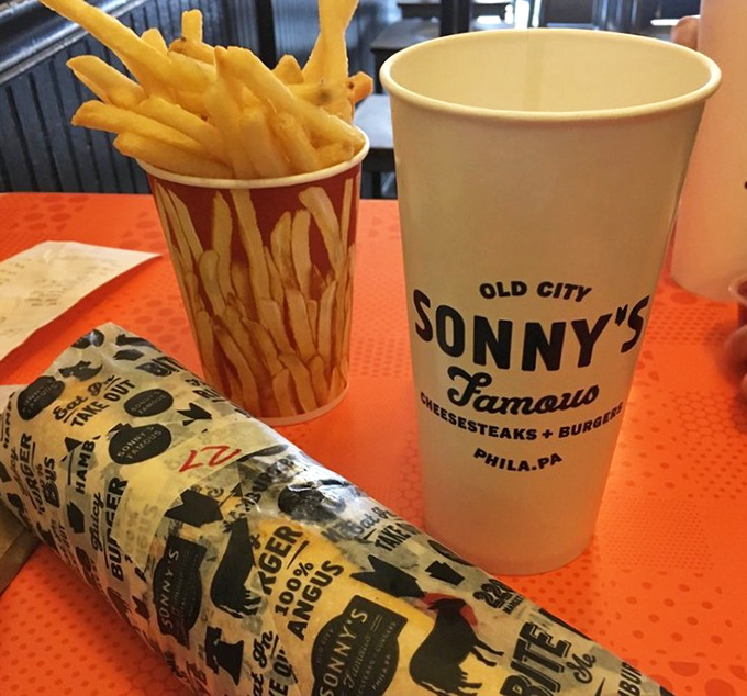 Simple pleasures done right: golden fries and a wrapped sandwich, presented on Sonny's signature paper&mdash;a love letter to Philadelphia street food.