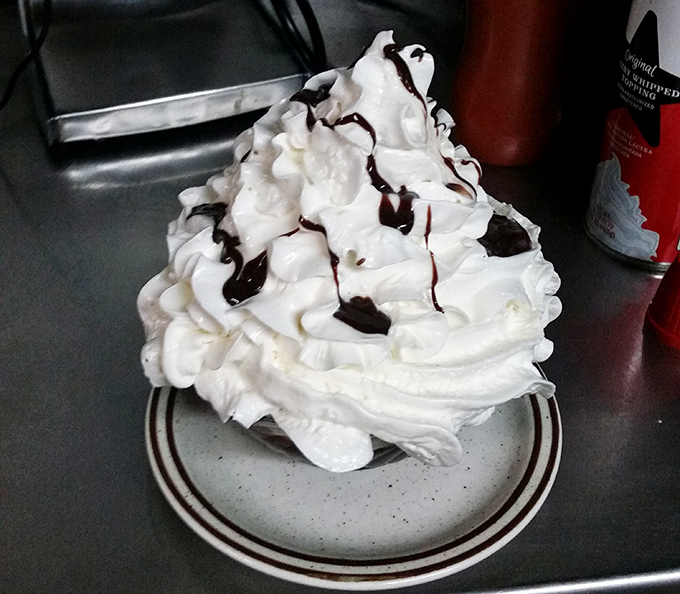 That towering hot fudge sundae says "diet starts tomorrow" in the most delicious way possible.