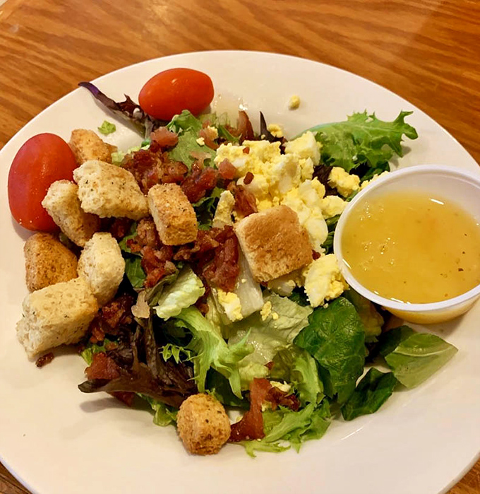 Even the house salad gets special treatment &ndash; fresh greens, croutons, and bacon bits waiting for their supporting role.