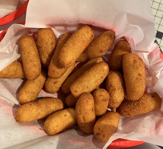 Golden-brown hush puppies that crunch then yield, these cornmeal treasures are what would happen if comfort food decided to become bite-sized.