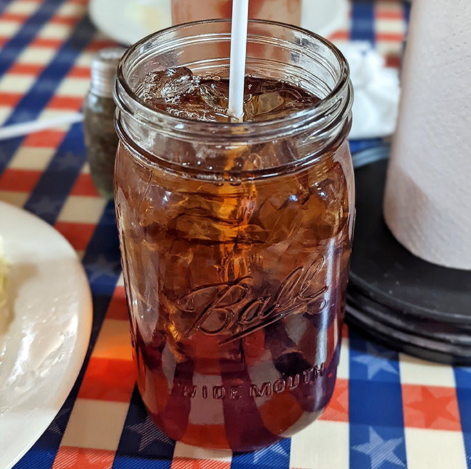 Sweet tea served in a Mason jar—because in Tennessee, drinking from anything else would be like eating spaghetti with a spoon. Just plain wrong.