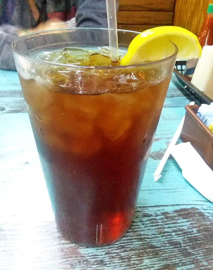 Sweet tea – the house wine of the South – served properly: ice-cold, lemon-adorned, and in a glass big enough to combat Georgia's famous heat.