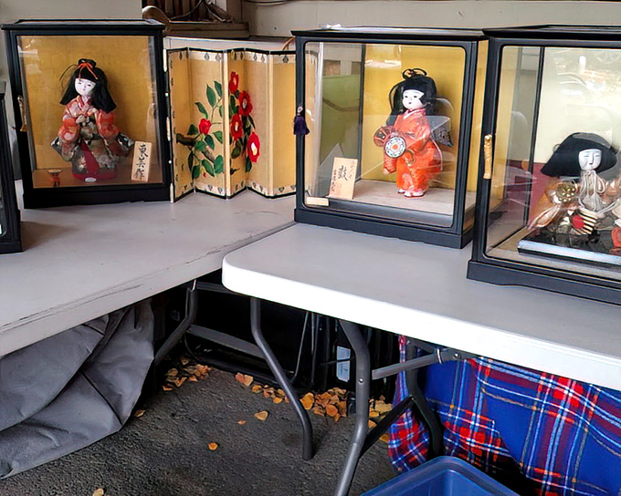 These delicate Japanese dolls in display cases remind us that one person's decluttering decision becomes another's cultural collection.