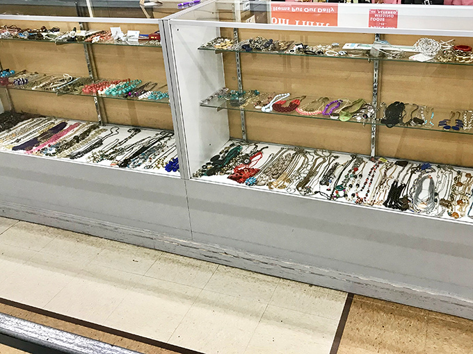 Jewelry displays that sparkle with potential under fluorescent lights. Someone's discarded accessories are about to become your conversation starters.