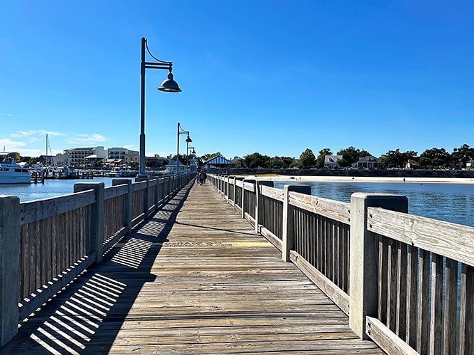 The Jimmy Rutherford Fishing Pier stretches toward possibility. Walking this boardwalk burns just enough calories to justify another beignet.
