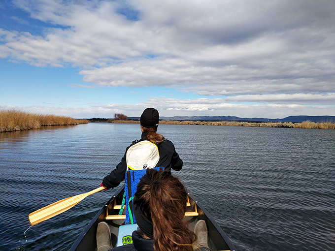 The original California highway system—two paddlers navigating through channels where no traffic jams exist, just occasional curious fish below.