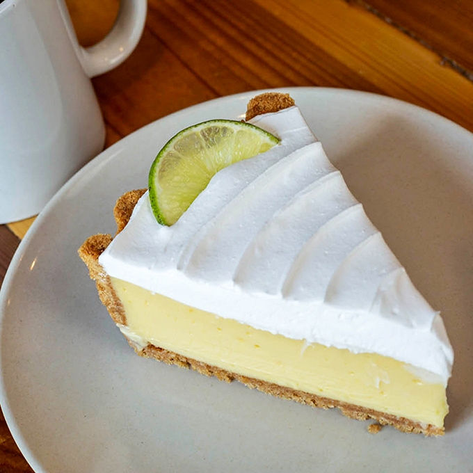 Key lime pie that strikes the perfect balance between sweet and tart &ndash; topped with a dollop of whipped cream and a lime slice for that vacation feeling.