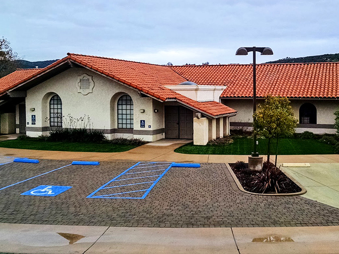 Spanish-style architecture that reminds you you're in California, not Florida. The red-tiled roof practically sings "West Coast" against that perfect blue sky.