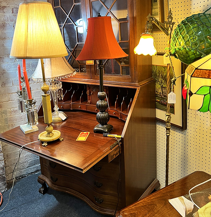 Lamp shopping here is illuminating in every sense. That secretary desk with its hidden compartments practically begs you to write mysterious correspondence by lamplight.