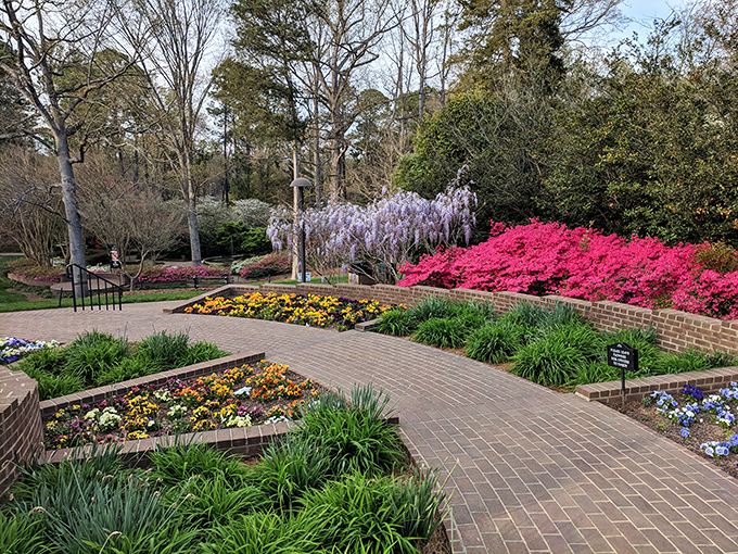 Brick pathways guide visitors through meticulously designed flower beds. Garden designers playing chess while the rest of us play checkers.