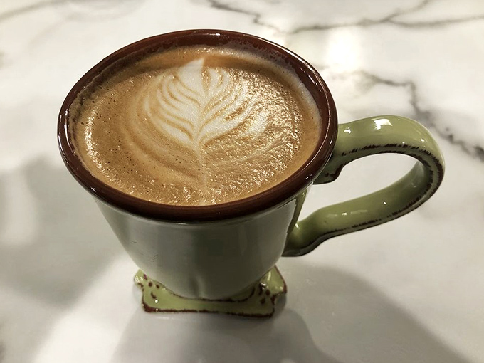 Latte art so pretty you almost don't want to drink it. Almost. The green mug adds that perfect touch of homey charm.