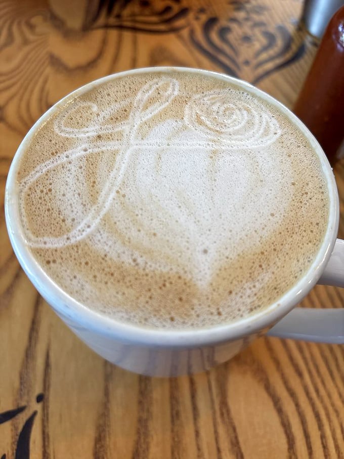 Coffee art so pretty you almost don't want to drink it. Almost. The wooden table underneath has witnessed countless caffeine-fueled epiphanies.