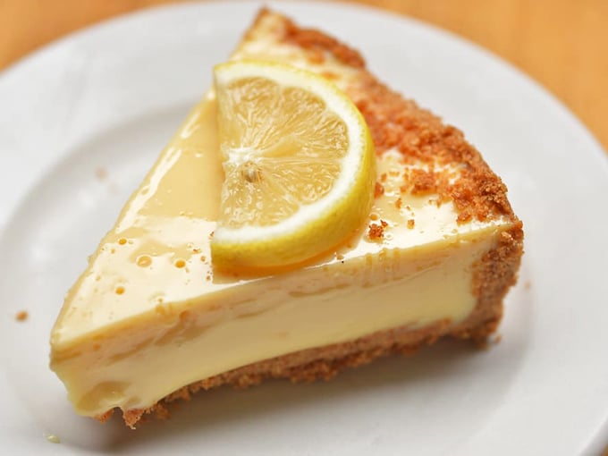 That lemon cheesecake slice looks refreshingly tangy and perfectly creamy—basically summer vacation captured in dessert form for your tastebuds.