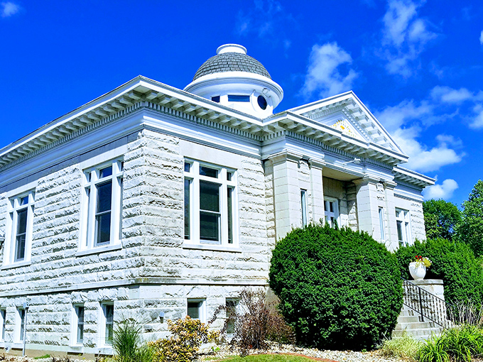 The stately library building whispers of an era when communities invested in knowledge with the same grandeur as cathedrals.