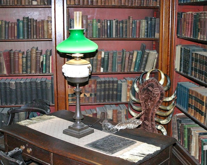The library's green-shaded lamp illuminates centuries of knowledge. Even in the 1800s, good lighting was essential for late-night page-turners.