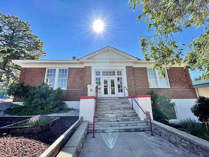 This brick building with its symmetrical windows and sunlit entrance has the dignified air of a place where knowledge and community come together.