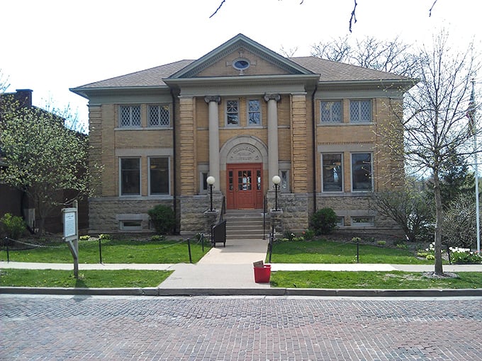 This isn't just a library; it's a temple to knowledge wrapped in limestone and civic pride, standing watch over brick streets since horses were the primary patrons.